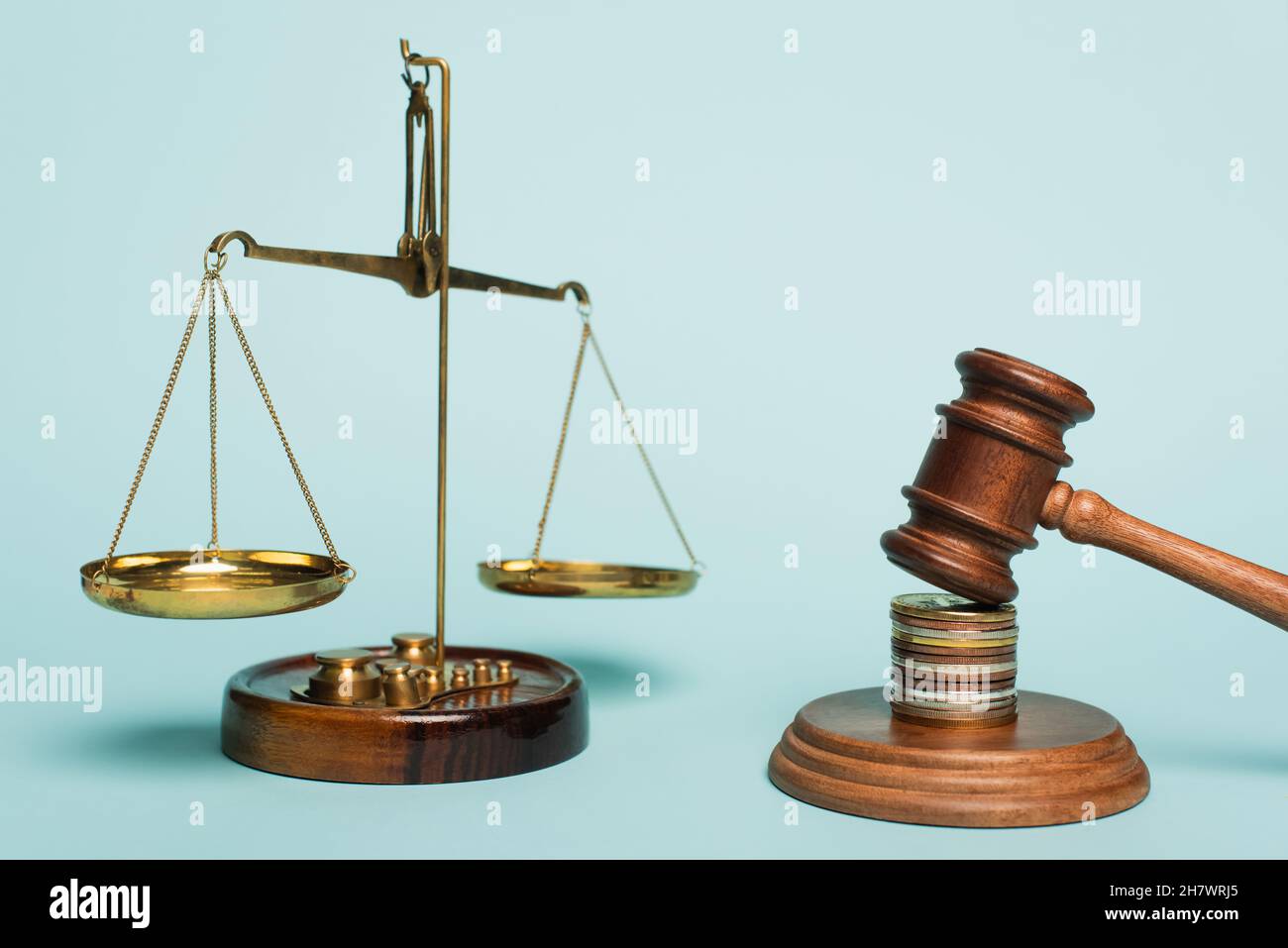 bronze justice scales, wooden gavel and coins on blue background, anti ...