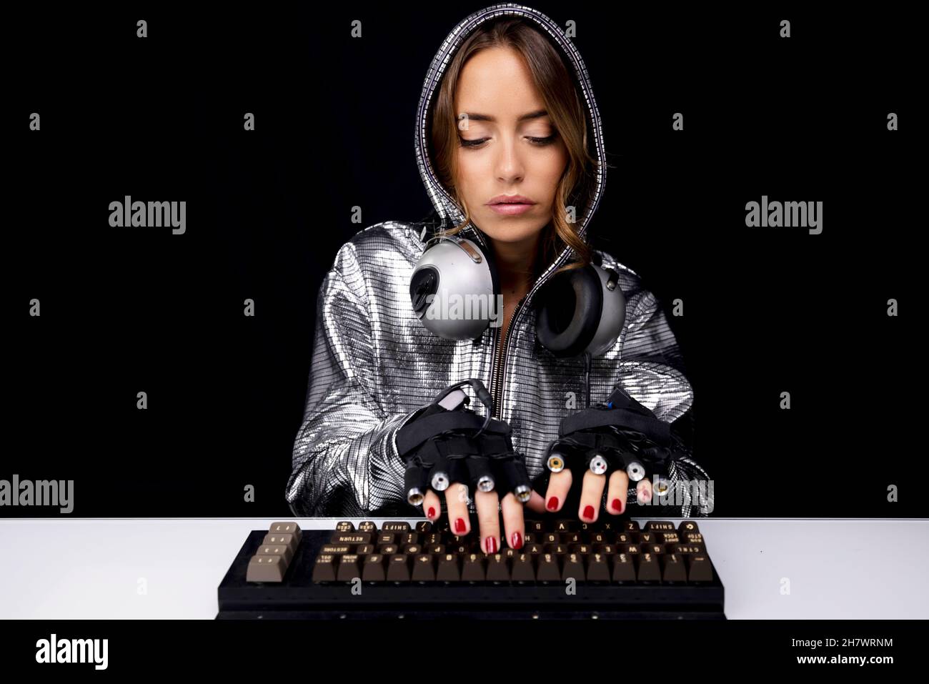 Woman with silver costume typing on keyboard Stock Photo - Alamy