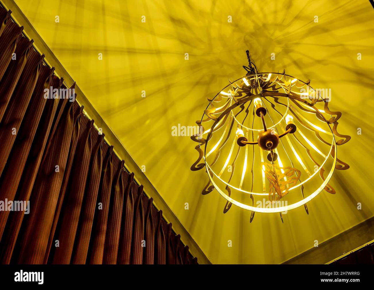 Warm colored light from a modern ceiling pendant lamp Stock Photo - Alamy