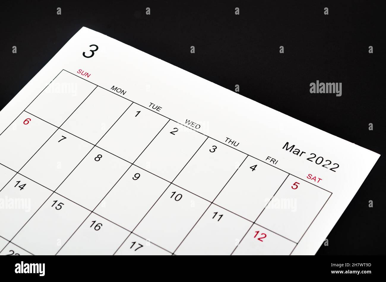 Close up March 2022 calendar sheet on black background Stock Photo - Alamy