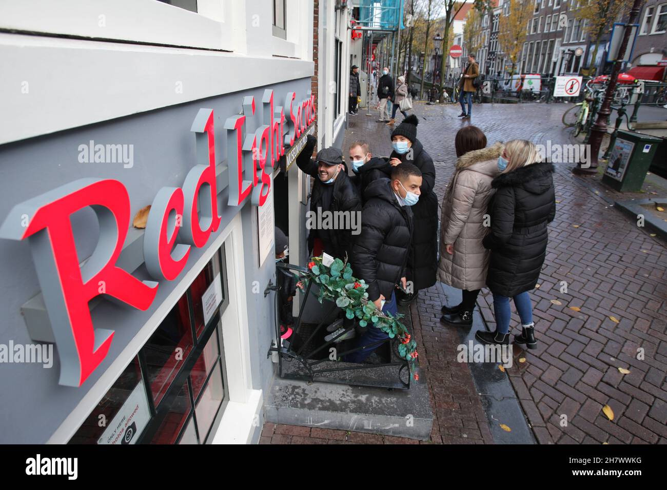Tourists line up wait to enter the Red Light Secret Prostitution Museum ...