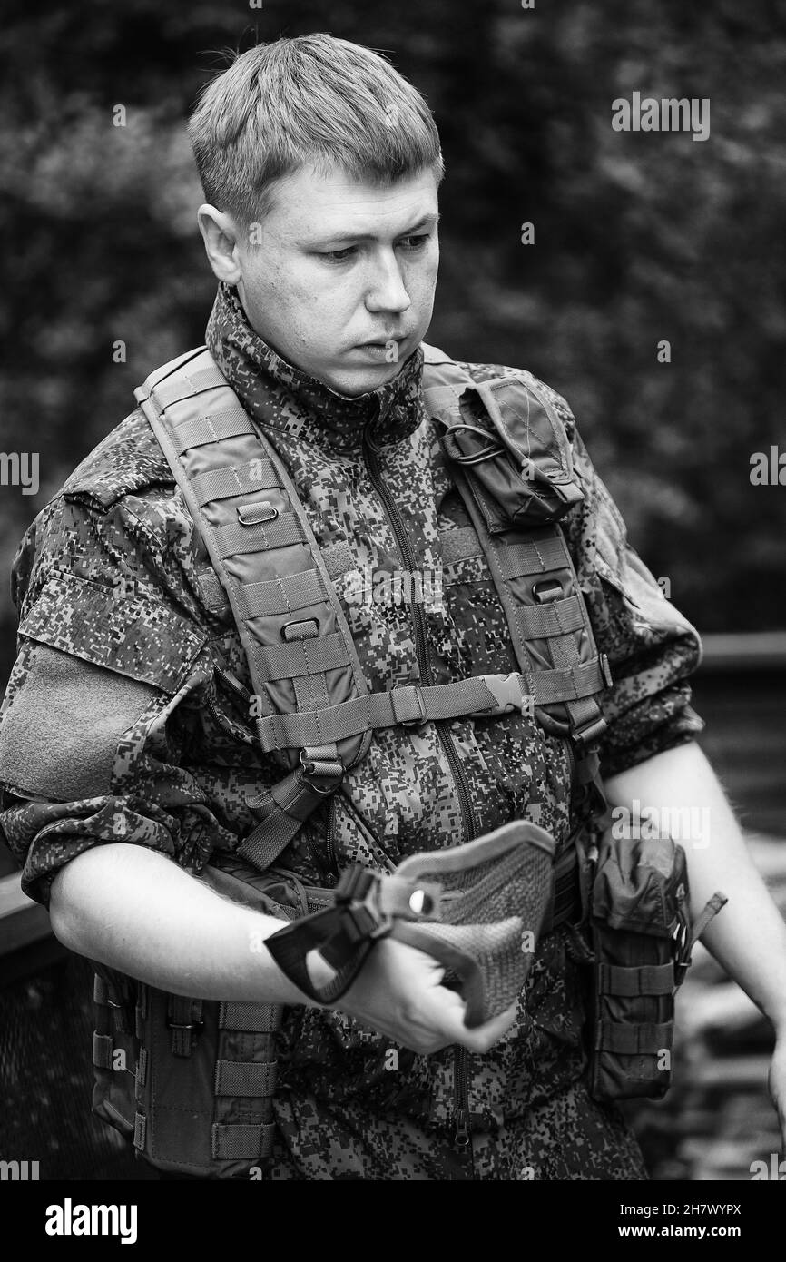 Fully equipped military men with automatic weapons getting ready to ...