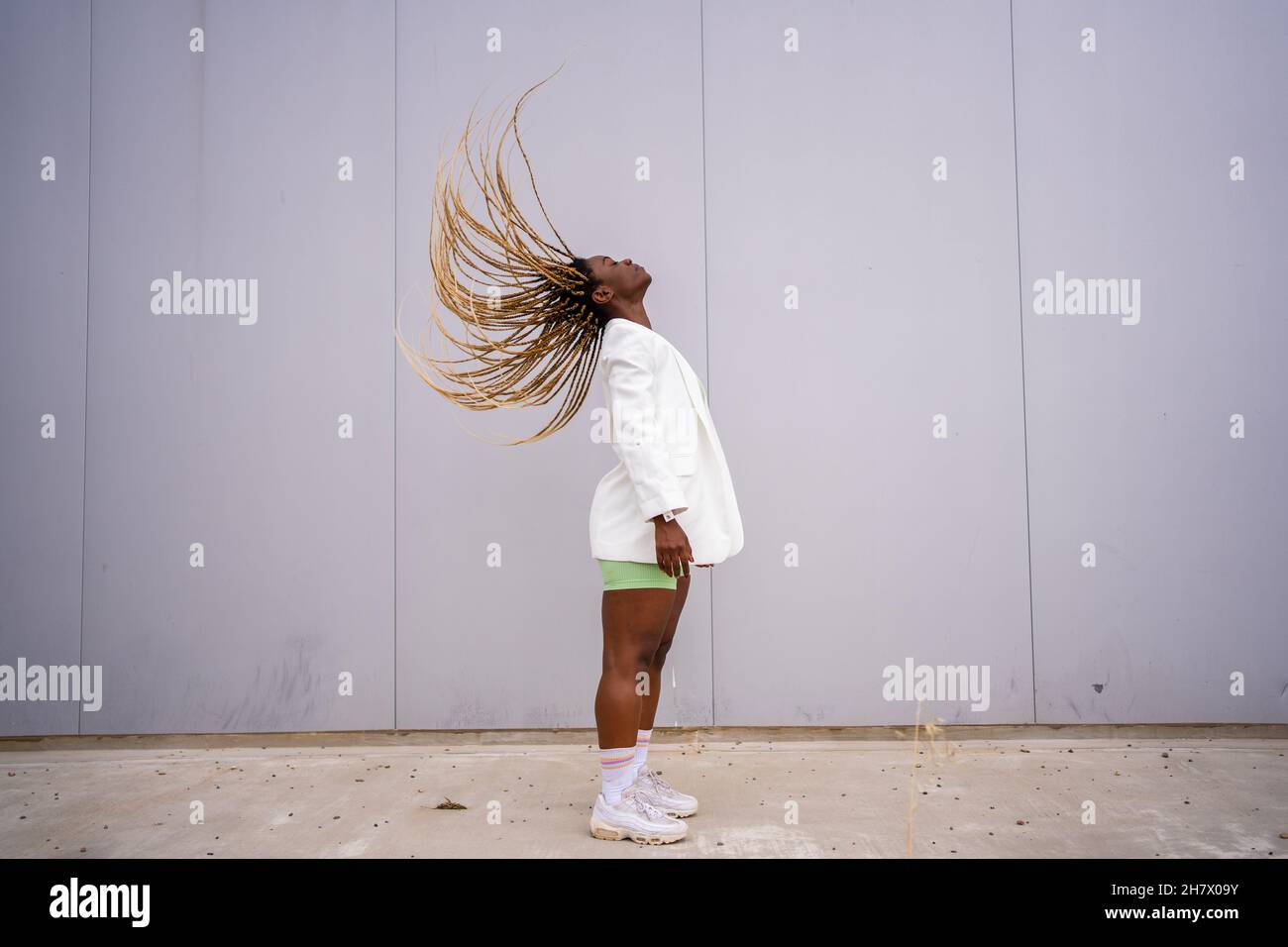 Photo with motion of a afro fit woman moving her braided hair to the ...