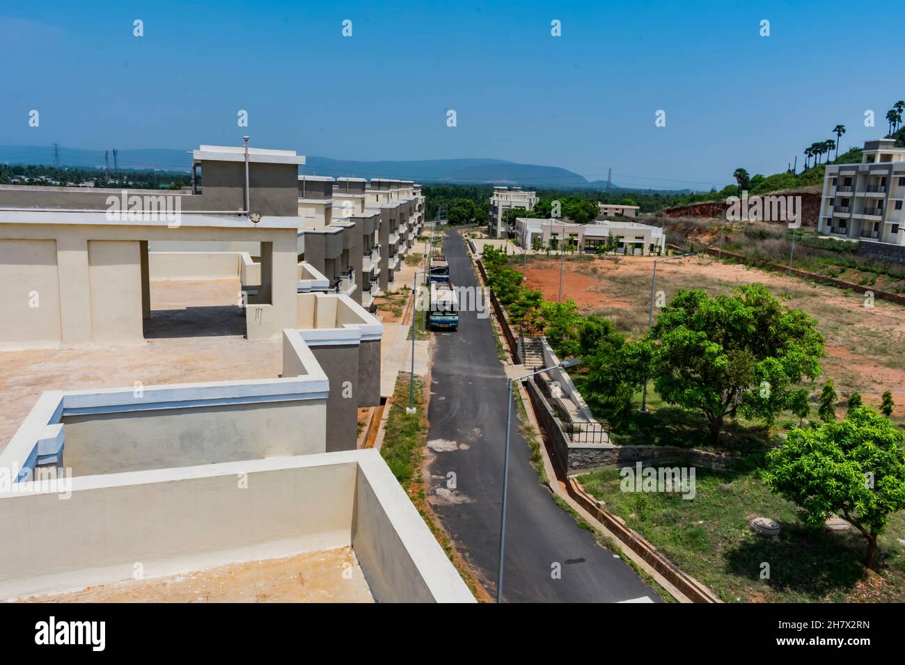 Top view of an Indian colony with bitumen road , building looking in ...