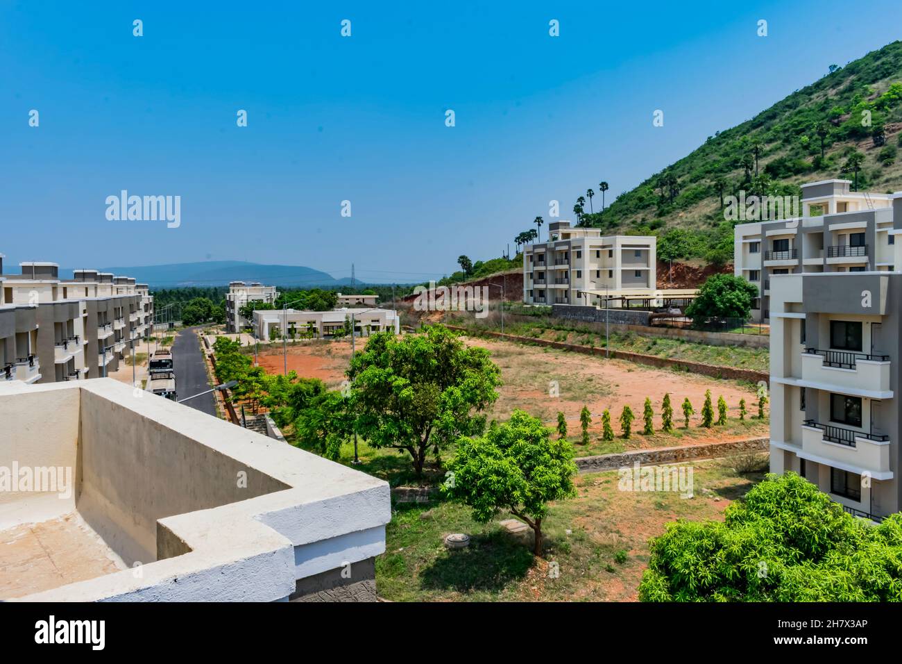 Top view of an Indian colony with bitumen road , building looking in ...