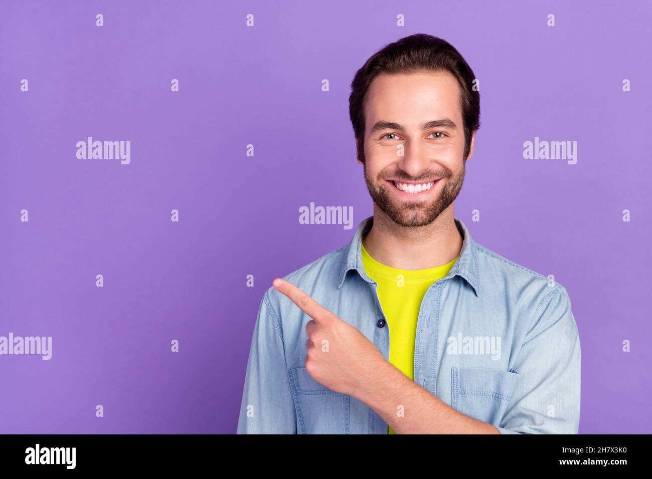 Photo of positive attractive guy pointing finger copyspace ...