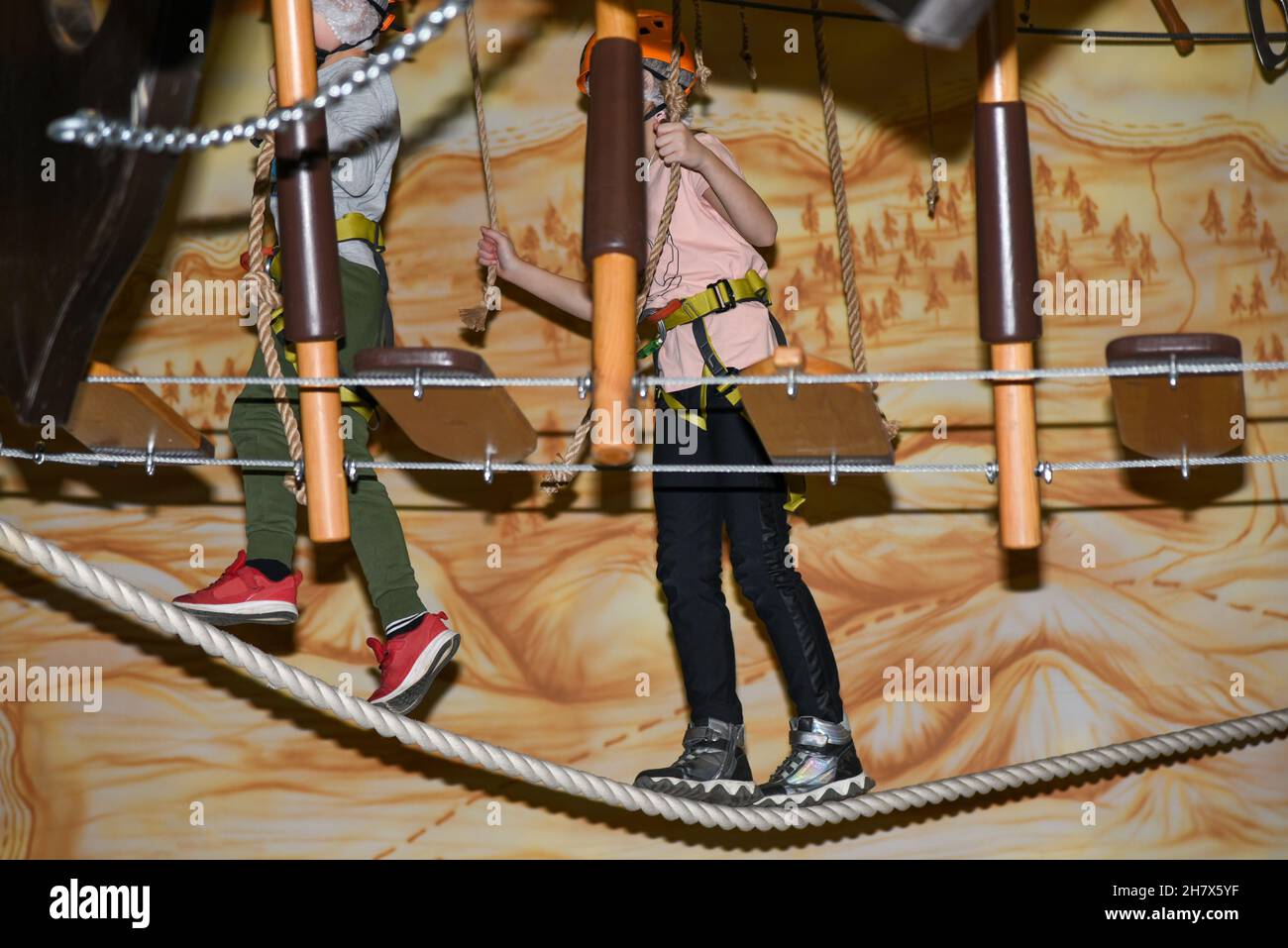 Active attraction kids move in the rope park Stock Photo - Alamy