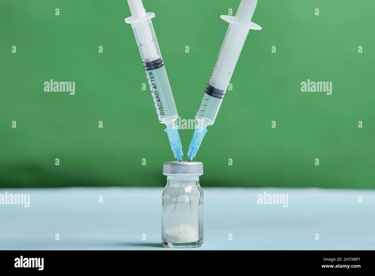 A covid-19 vaccine vial with syringes. Covid-19 vaccine booster dose ...