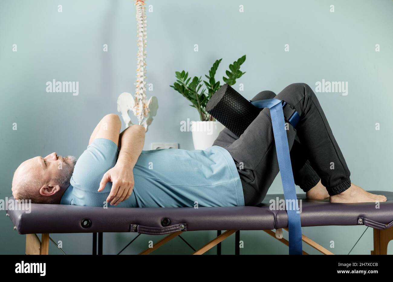 A man lying on the massage table in constructive rest postion with foam ...