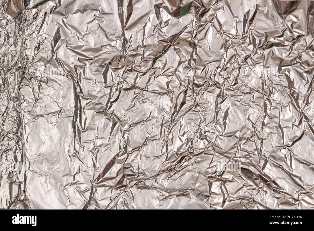 Silver shiny crumpled foil texture background. Top view Stock Photo - Alamy