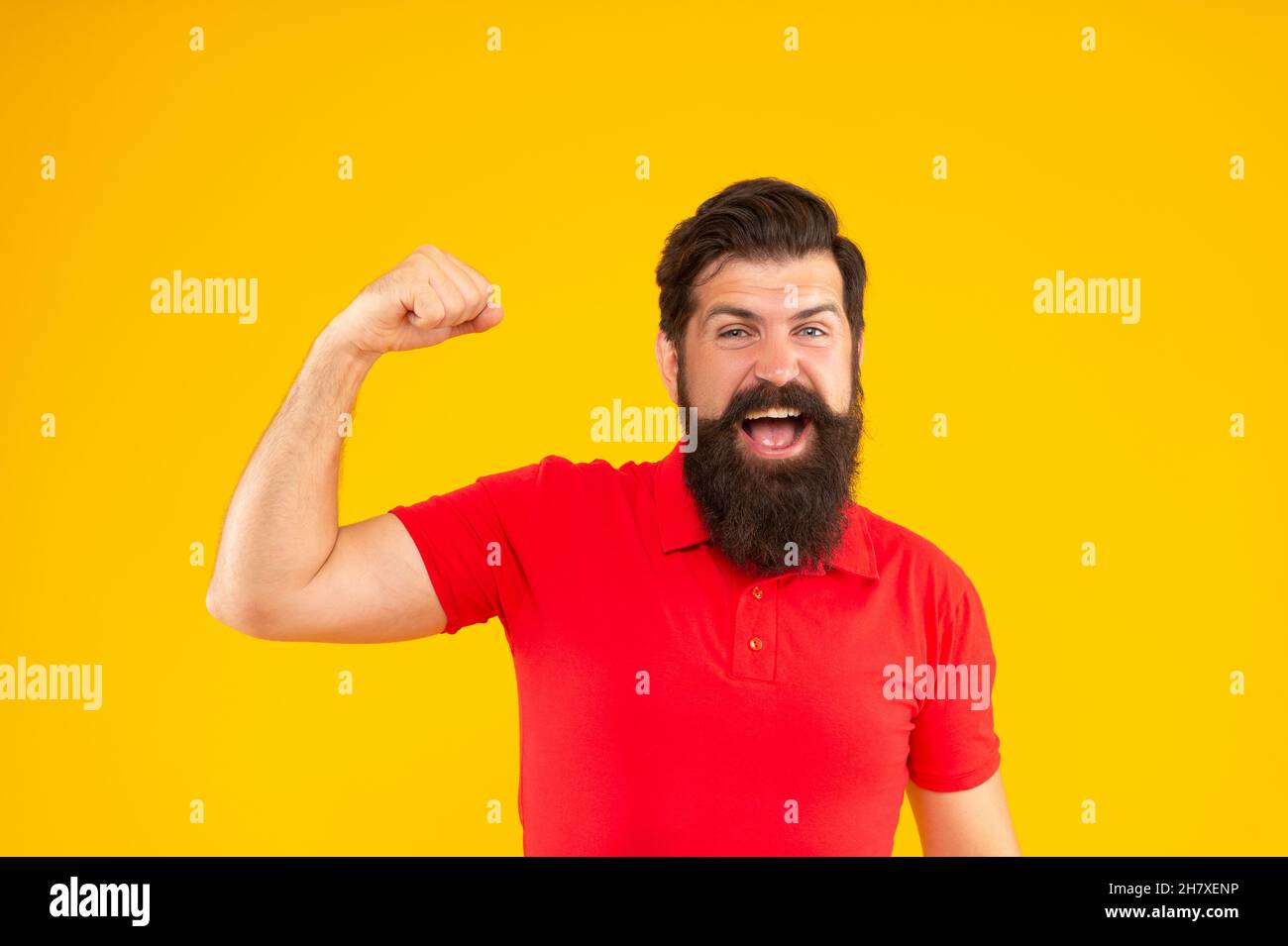 happy strong guy with beard and hairstyle on yellow background ...