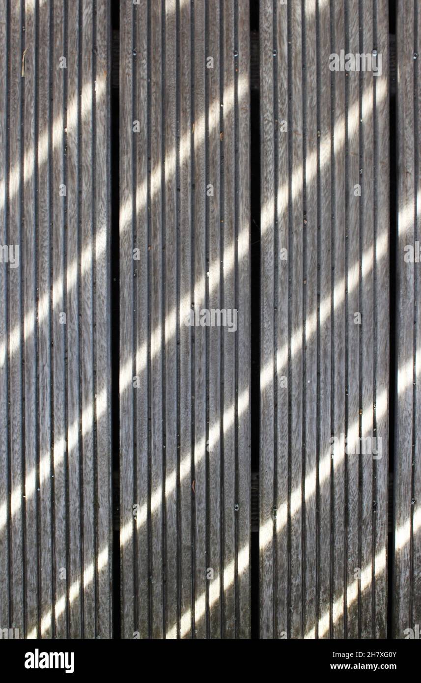 Sun rays create a pattern of lines on the wooden floor Stock Photo - Alamy