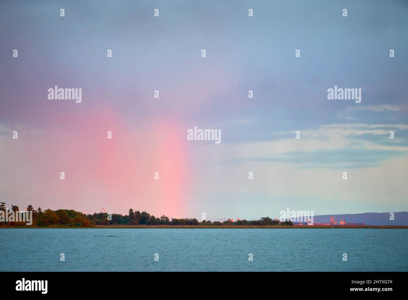 Fraser River Rainbow Storm. Storm clouds and a rainbow over the Fraser ...