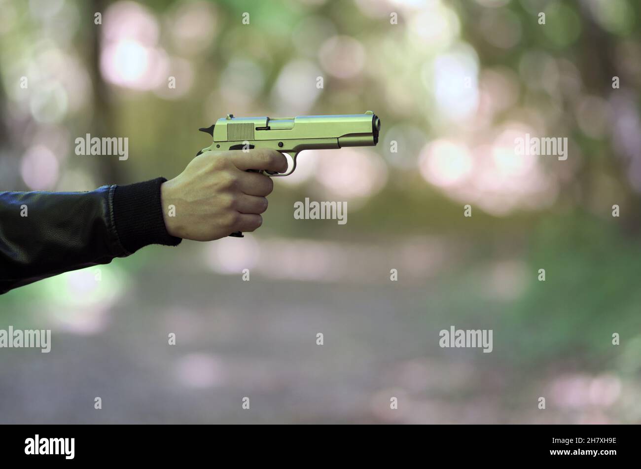 Colt weapon in the hand Stock Photo - Alamy