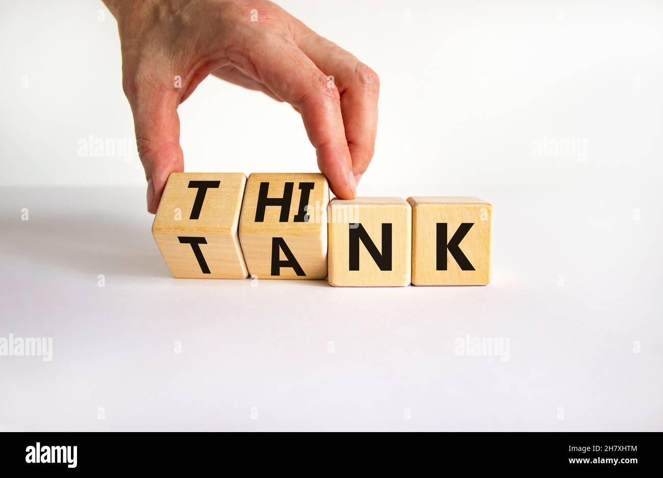 Think tank symbol. Businessman turns wooden cubes and changes the word ...