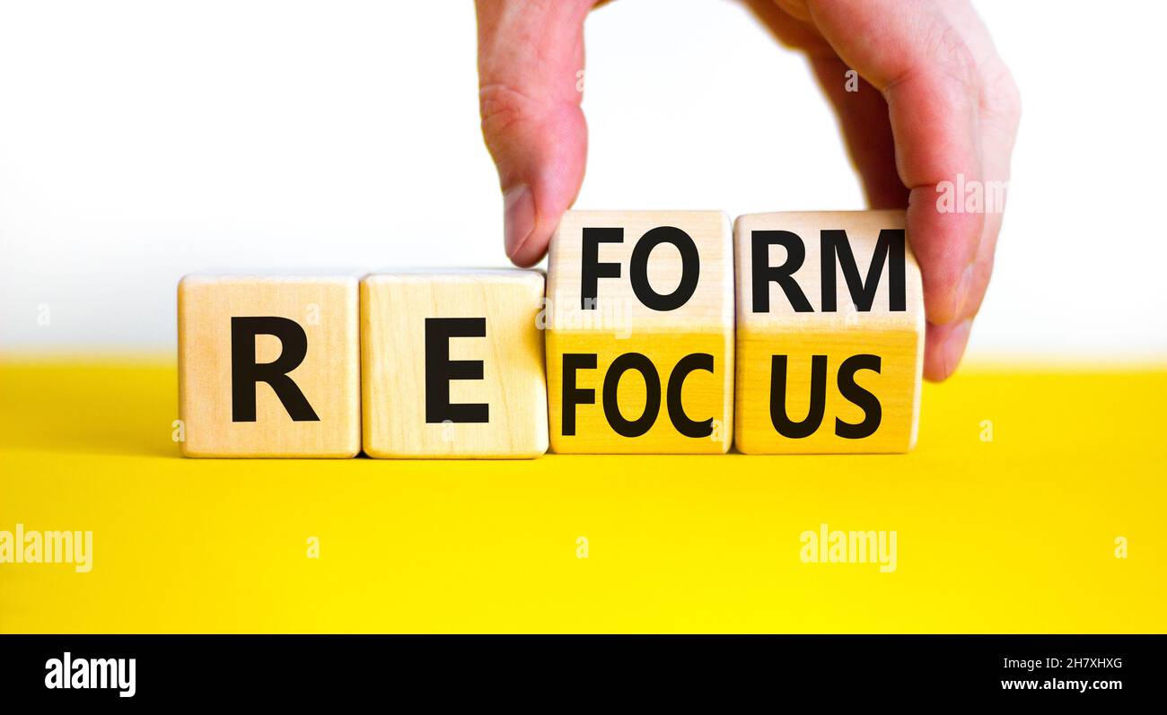 Refocus and reform symbol. Businessman turns cubes and changes the word ...