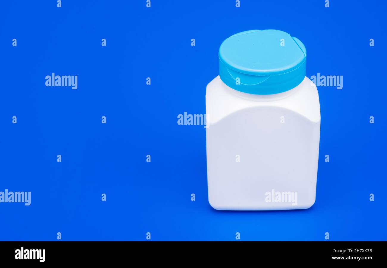 food supplement. presenting vitamin product. white unbranded pill jar ...