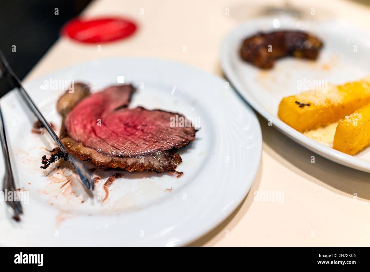 Brazilian steakhouse restaurant table plate with tongs in churrascaria ...