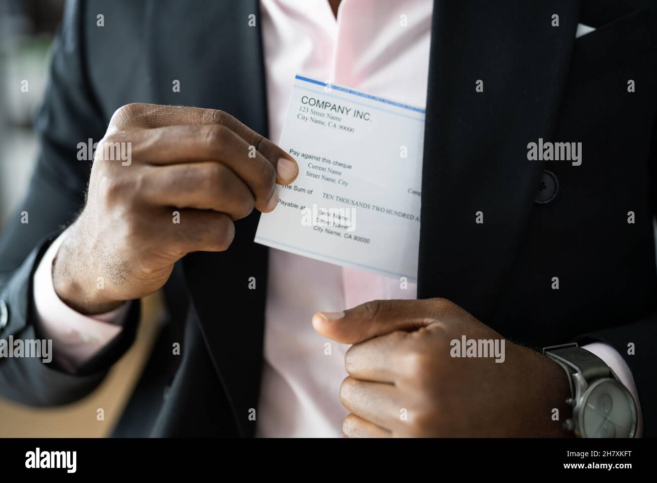Man holding cheque hi-res stock photography and images - Alamy