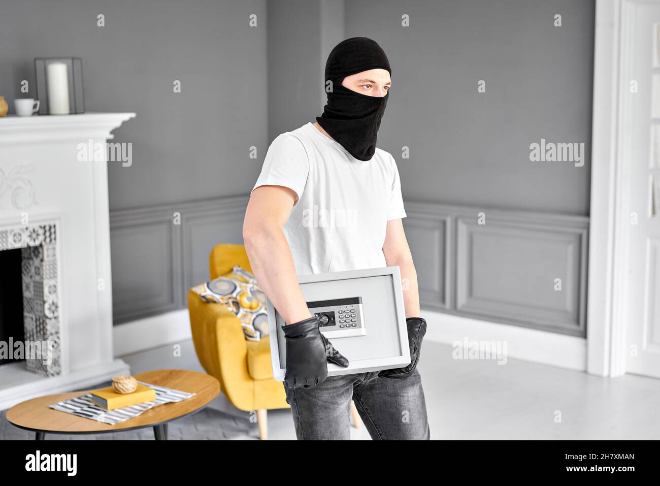 Thief with black balaclava stealing modern expensive television. Masked ...