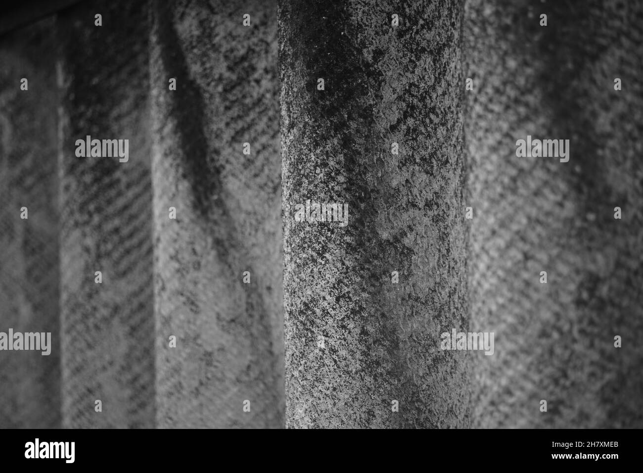 Closeup old slate sheet fence. BW photo Stock Photo - Alamy