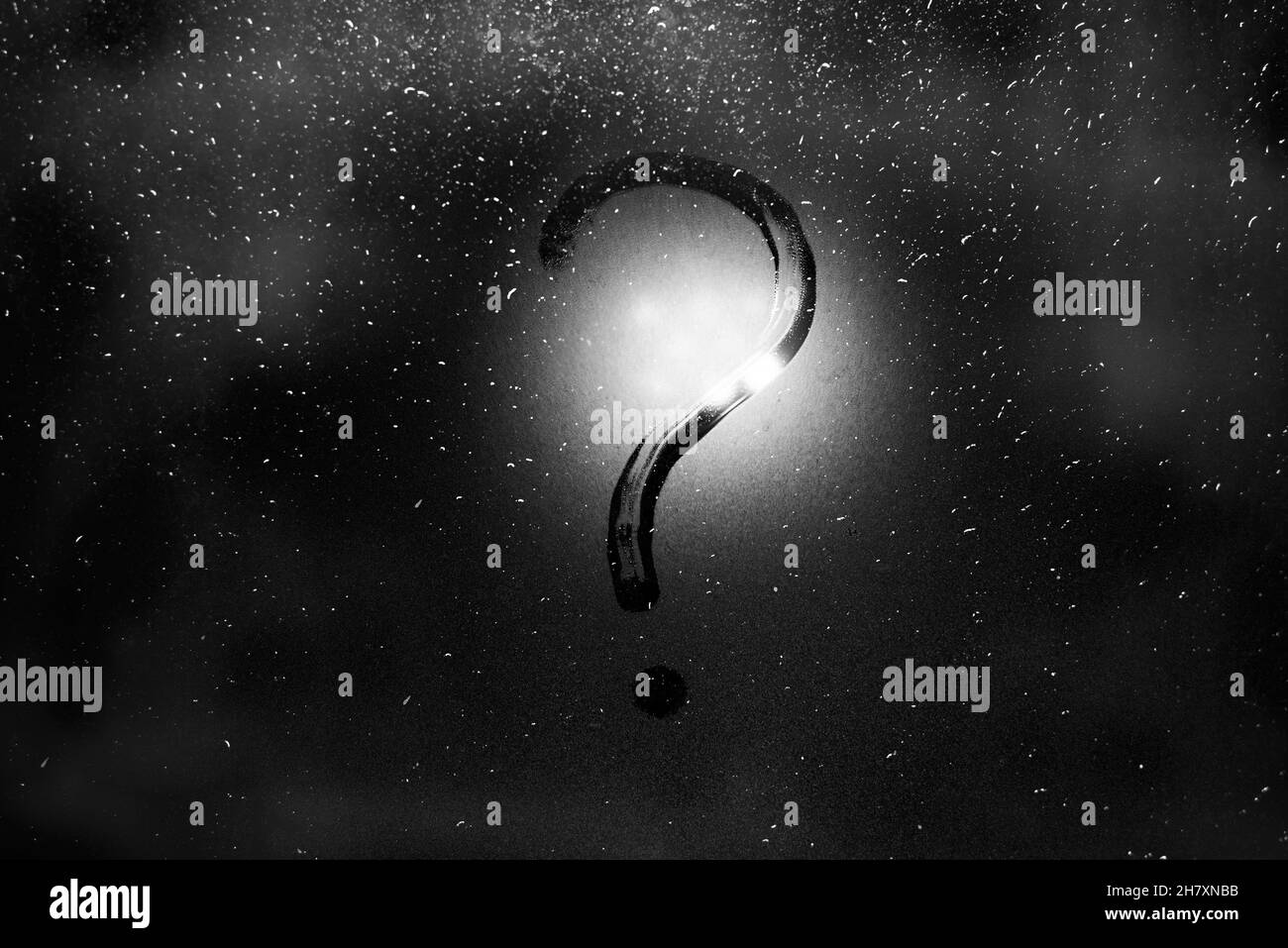 A question mark on rain-wet glass. Water drops on the window. Question ...