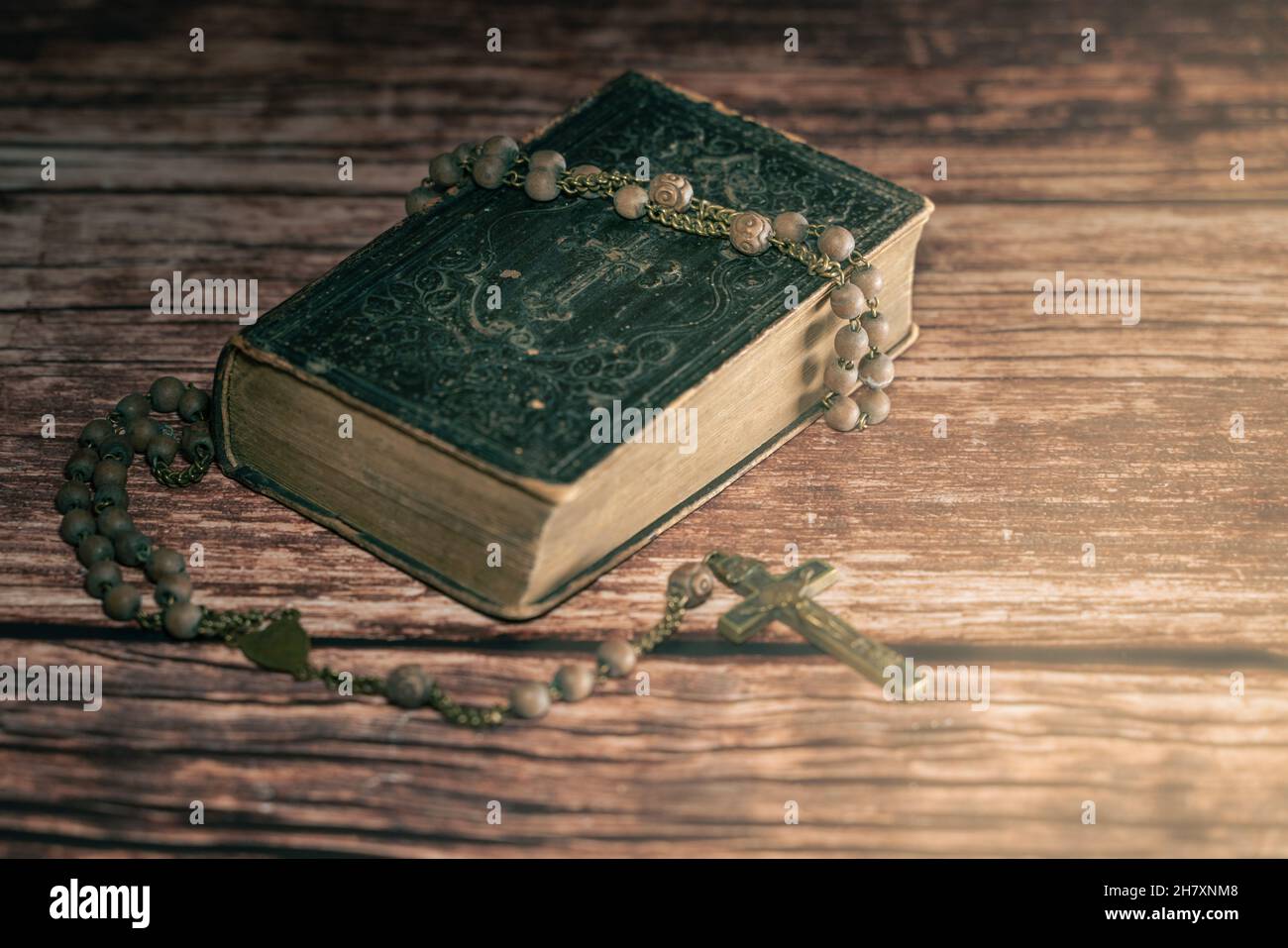 Wide studio shot of very old, vintage Holy Bible with lots of ornaments ...