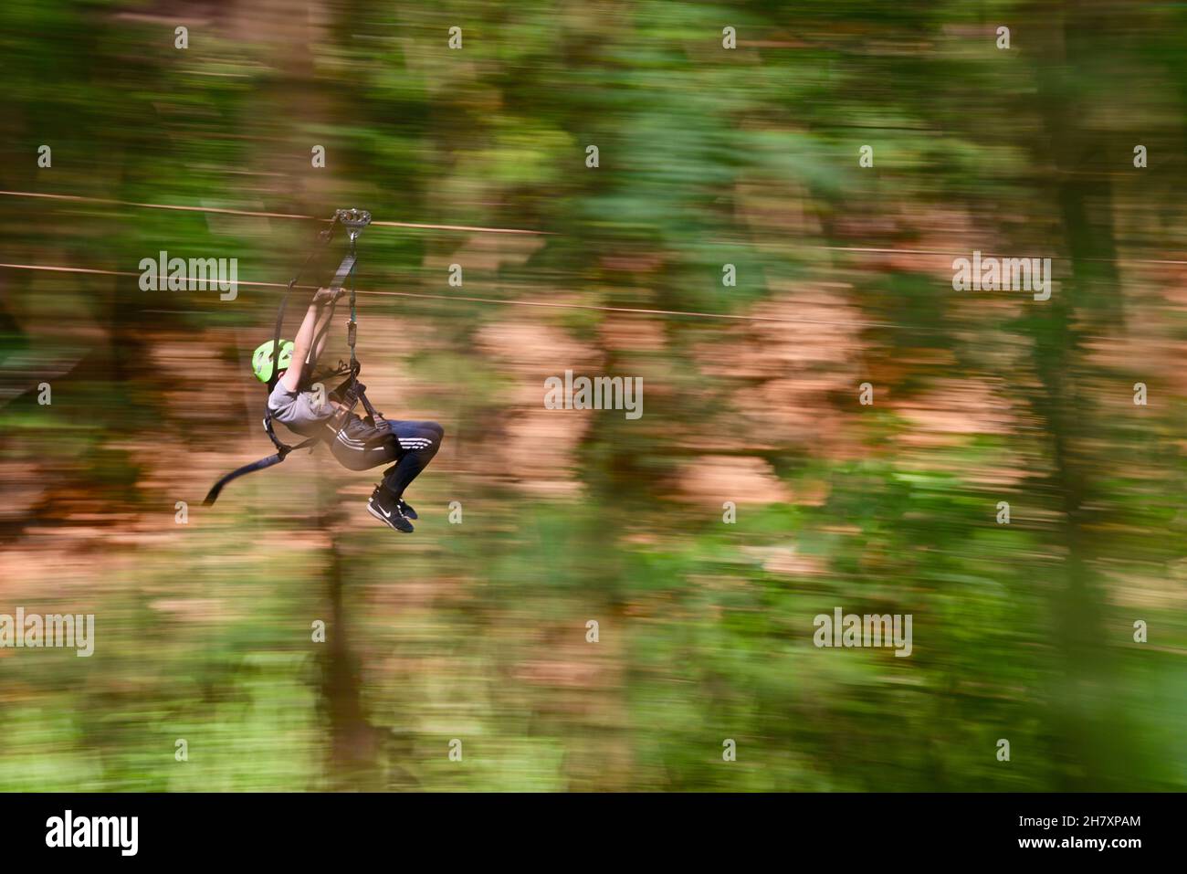 Fast moving motion, thrill and excitement of zipline run down tropical ...