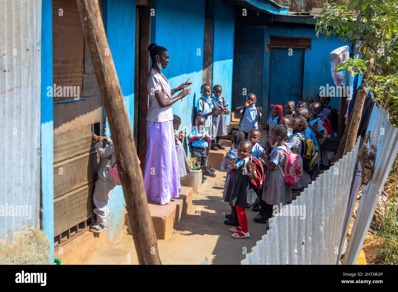 A teacher plays with kids during the international day for the ...
