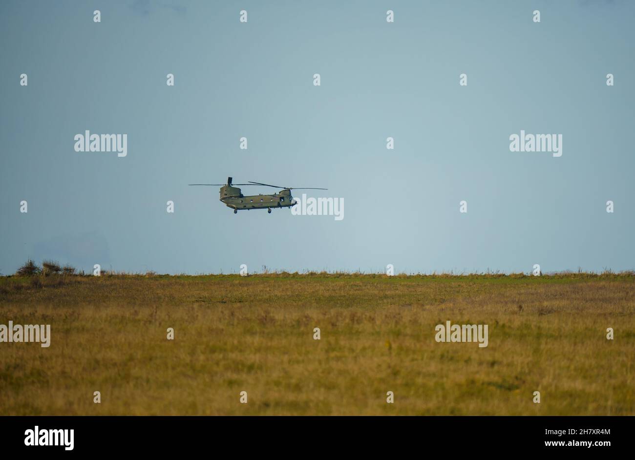 RAF Chinook tandem-rotor CH-47 helicopter flying fast and low in a ...