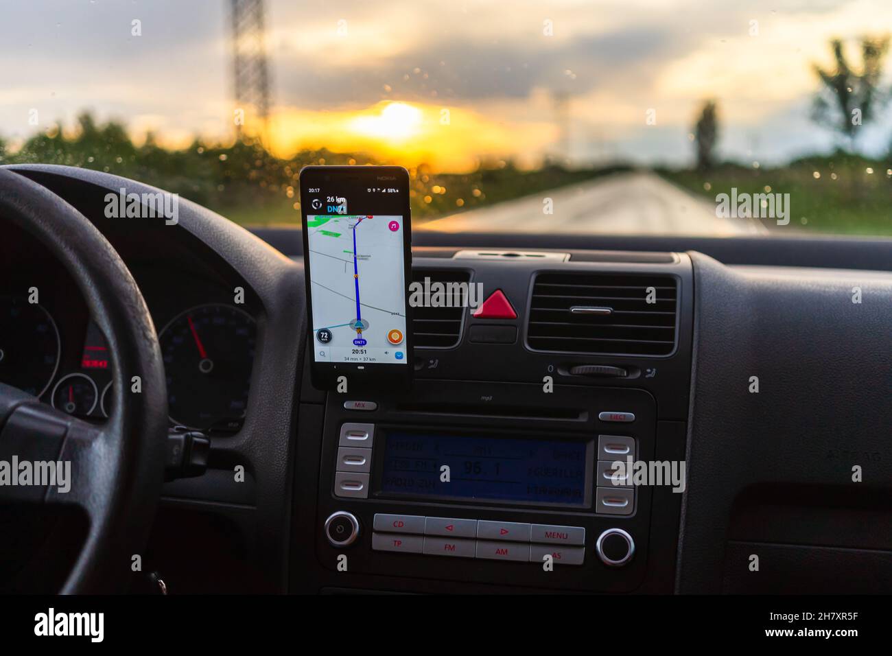 Using waze maps application on smartphone on car dashboard, Driver ...