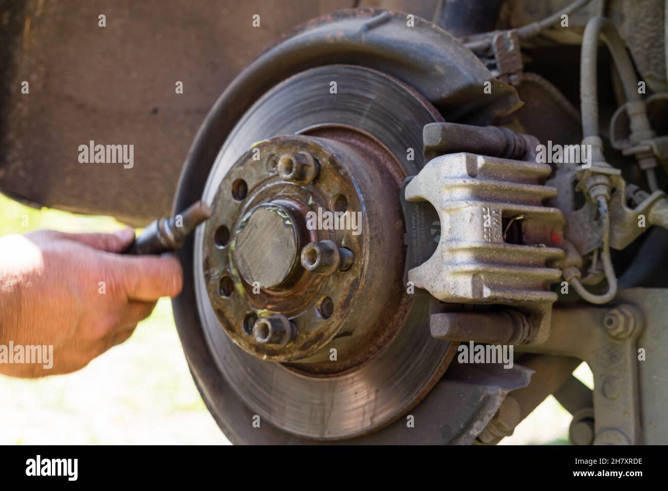 Mechanic cleaning and fixing the brake system of a car in Romania ...