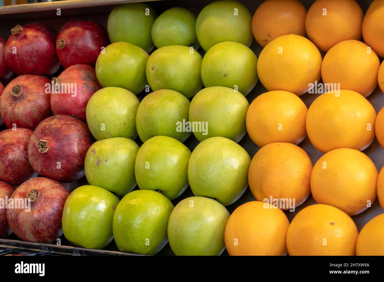Pomegranate and tropical fruits, apples, orange fruits on display at ...