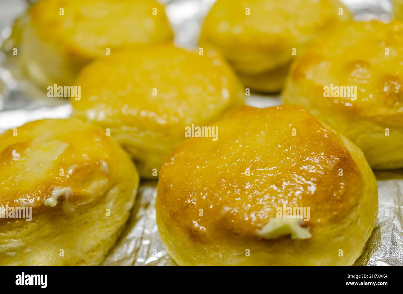 Southern-style biscuits are topped with butter, Jan. 18, 2016, in Coden ...