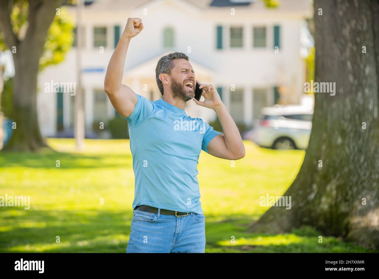 happy unshaven guy speaking on phone emotionally, conversation Stock ...