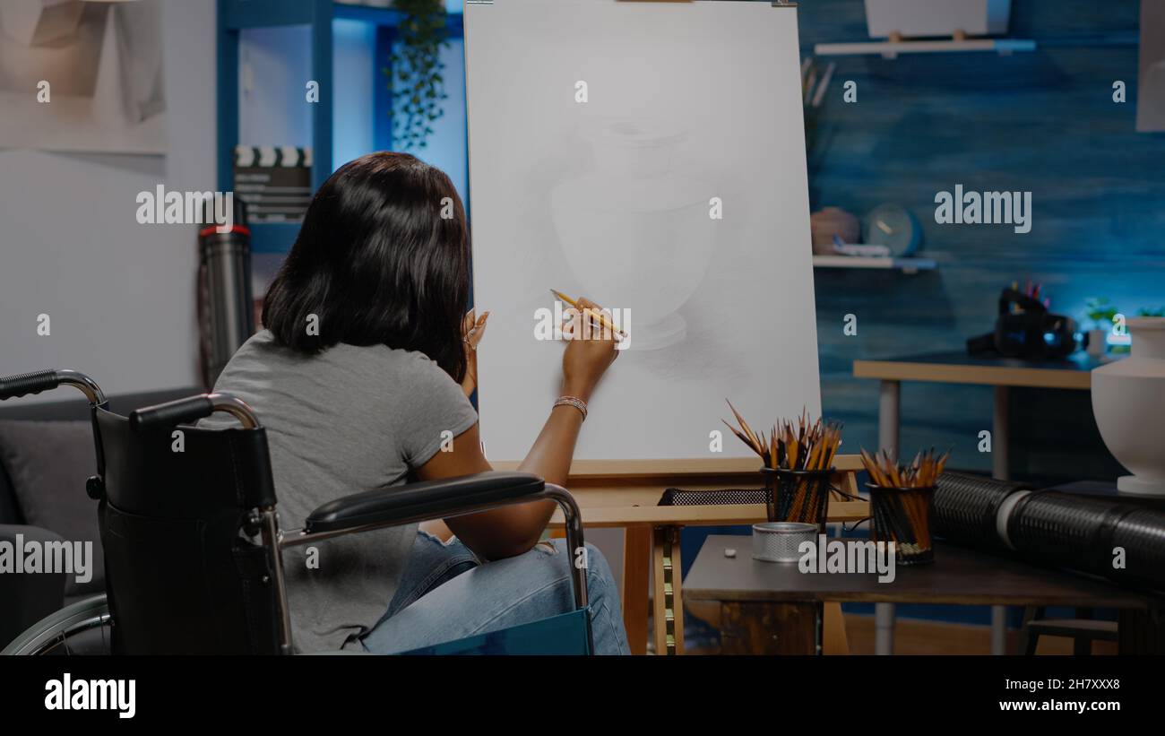 African american artist with disability drawing vase design for ...