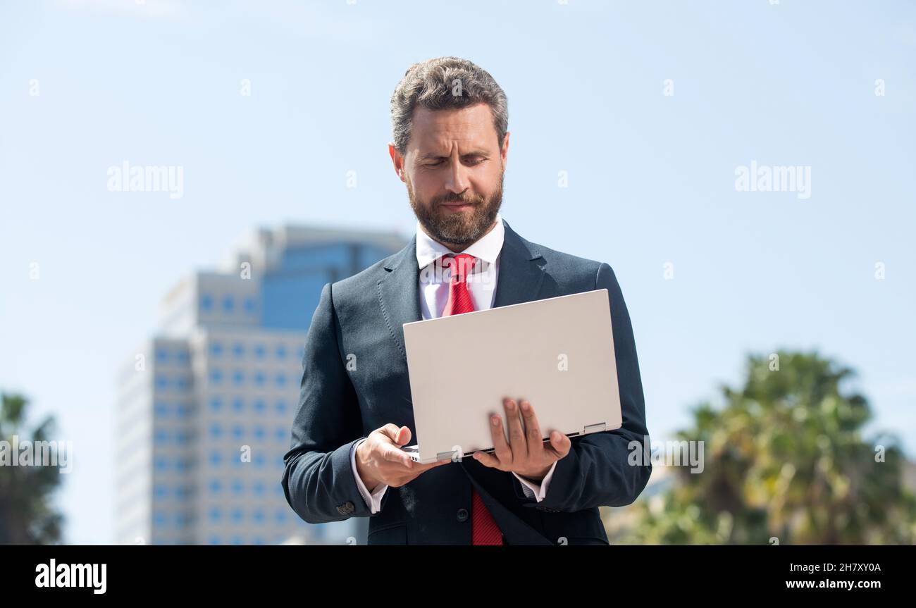 busy businessman using laptop for blogging. social network and weblog ...