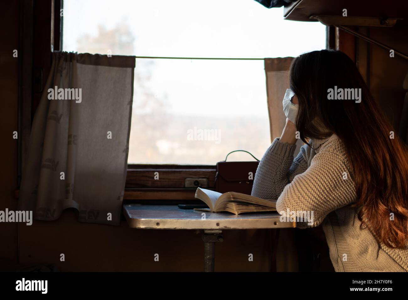 Girl sitting alone in train hi-res stock photography and images - Alamy