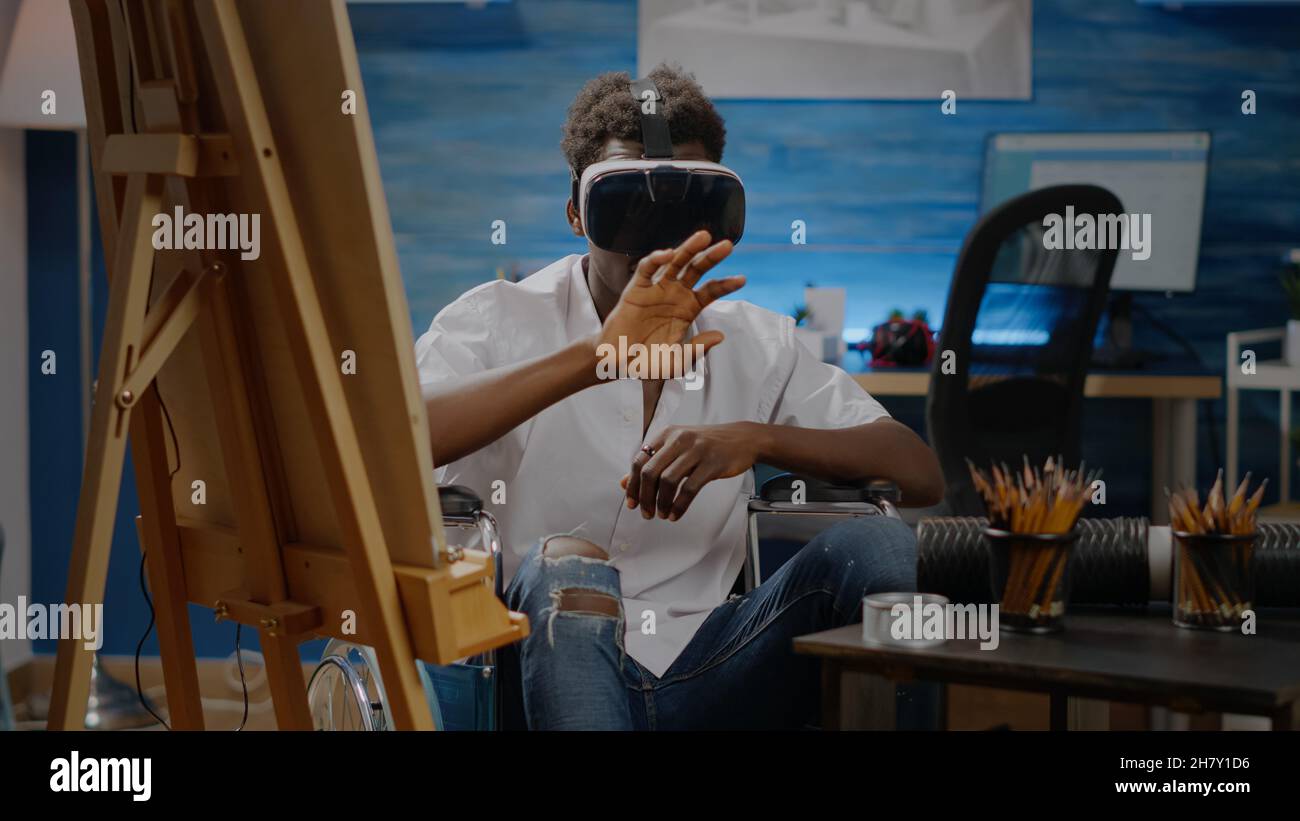 Invalid african american person using vr goggles for fine art creation ...