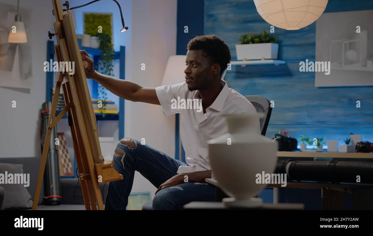 Artist of african american ethnicity drawing vase design for fine art ...