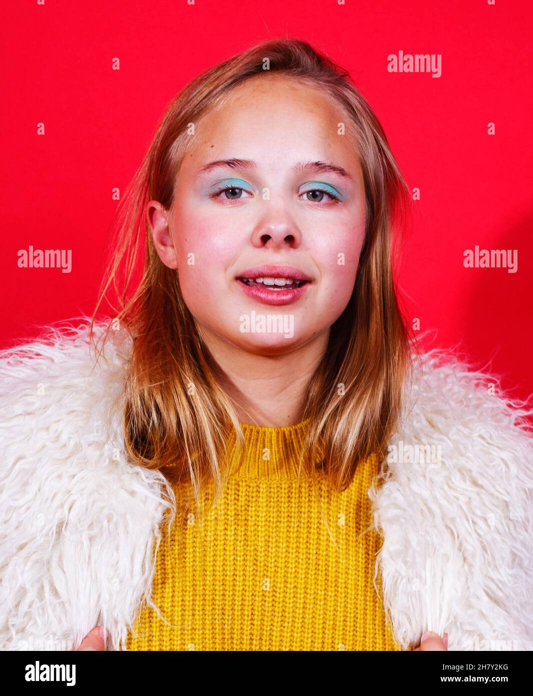 young pretty emitonal posing teenage girl on bright red background ...