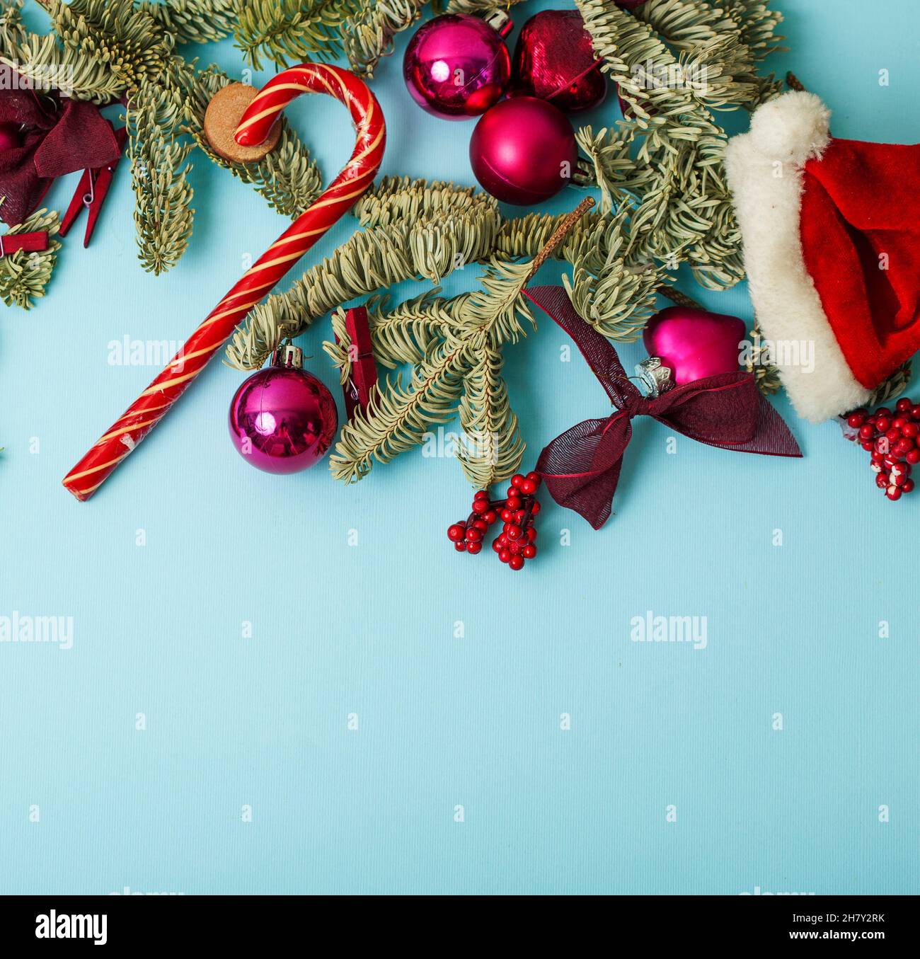 christmass stuff laying flat on colorful background, branch of tree ...