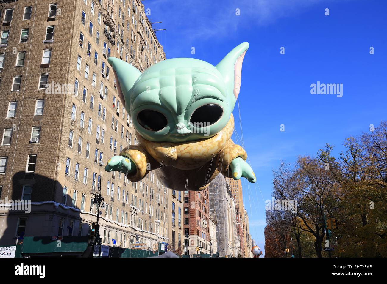 The Grogu balloon is led down Central Park West in the 95th Macy's ...