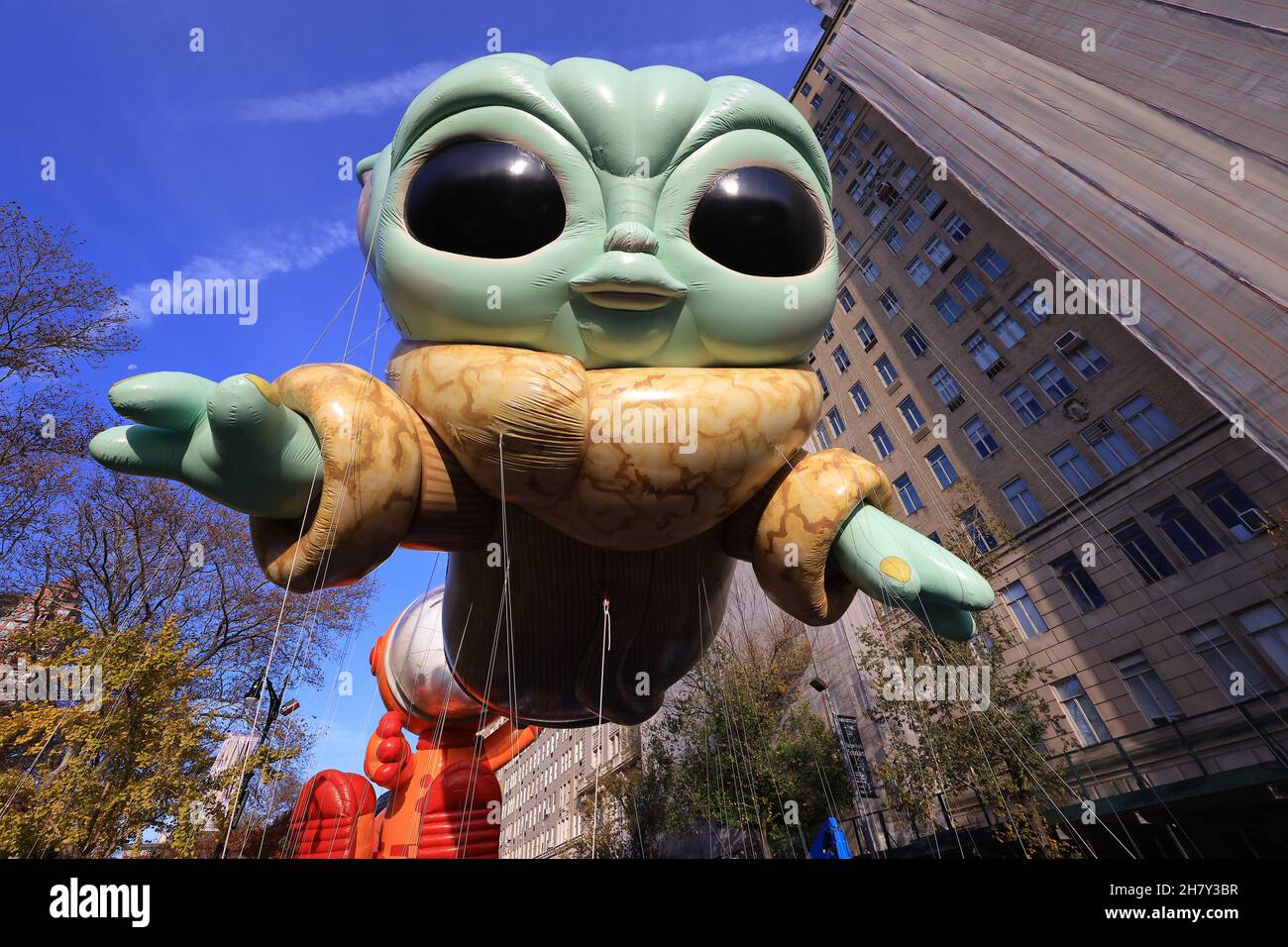 The Grogu balloon is led down Central Park West in the 95th Macy's ...