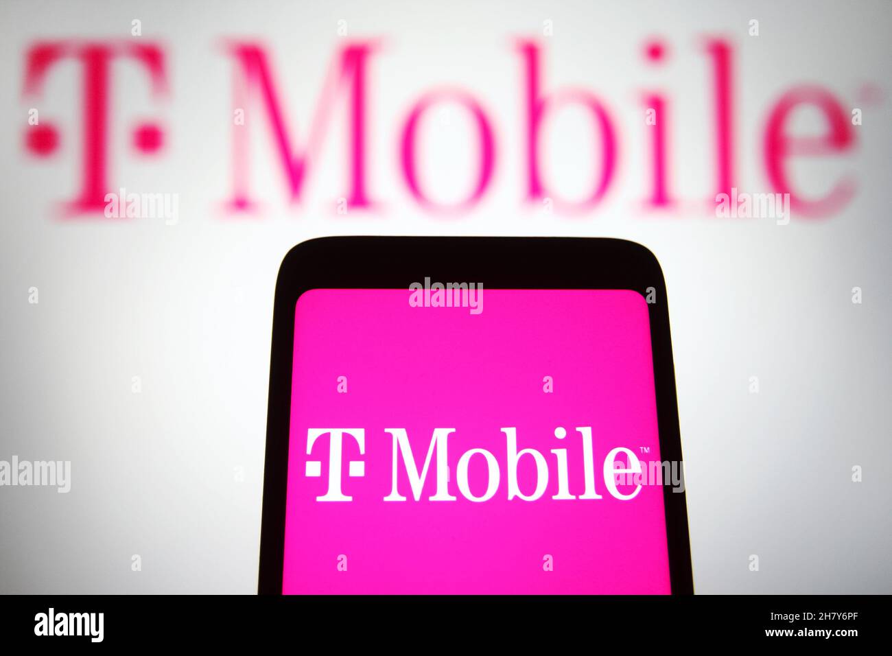 In this photo illustration, a T-Mobile US Inc. logo is seen on a ...
