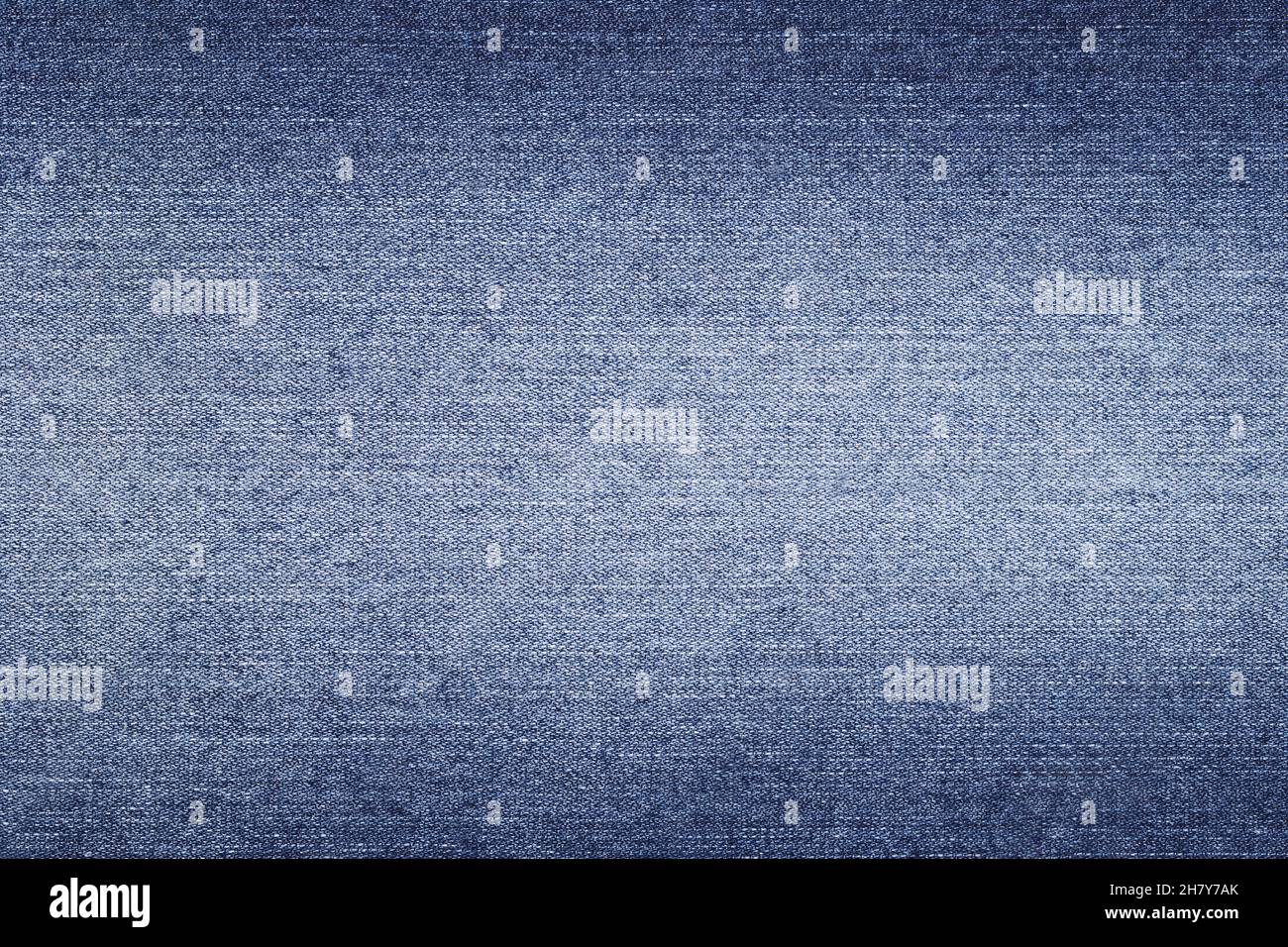 Denim background in blue fabric with faded. Blue discolored jeans close ...