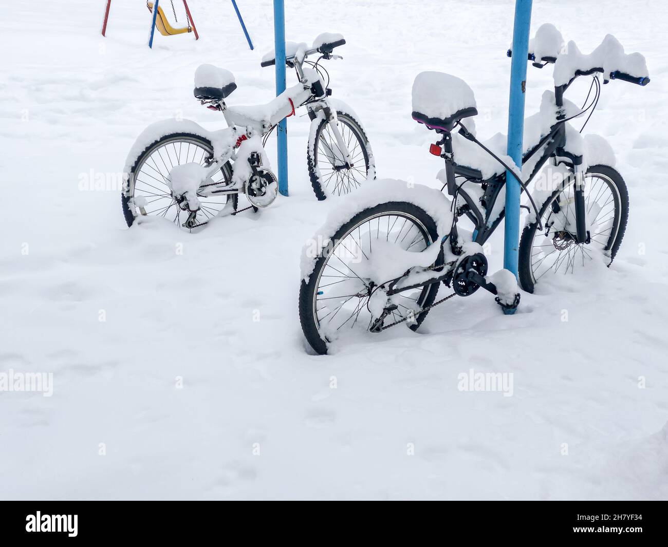 snow-covered bicycles after snowfall. winter in the city Stock Photo ...