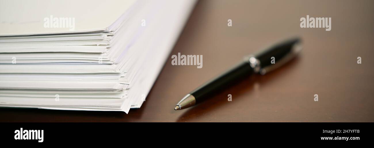 White paper and pen on desk. Business concept Stock Photo - Alamy