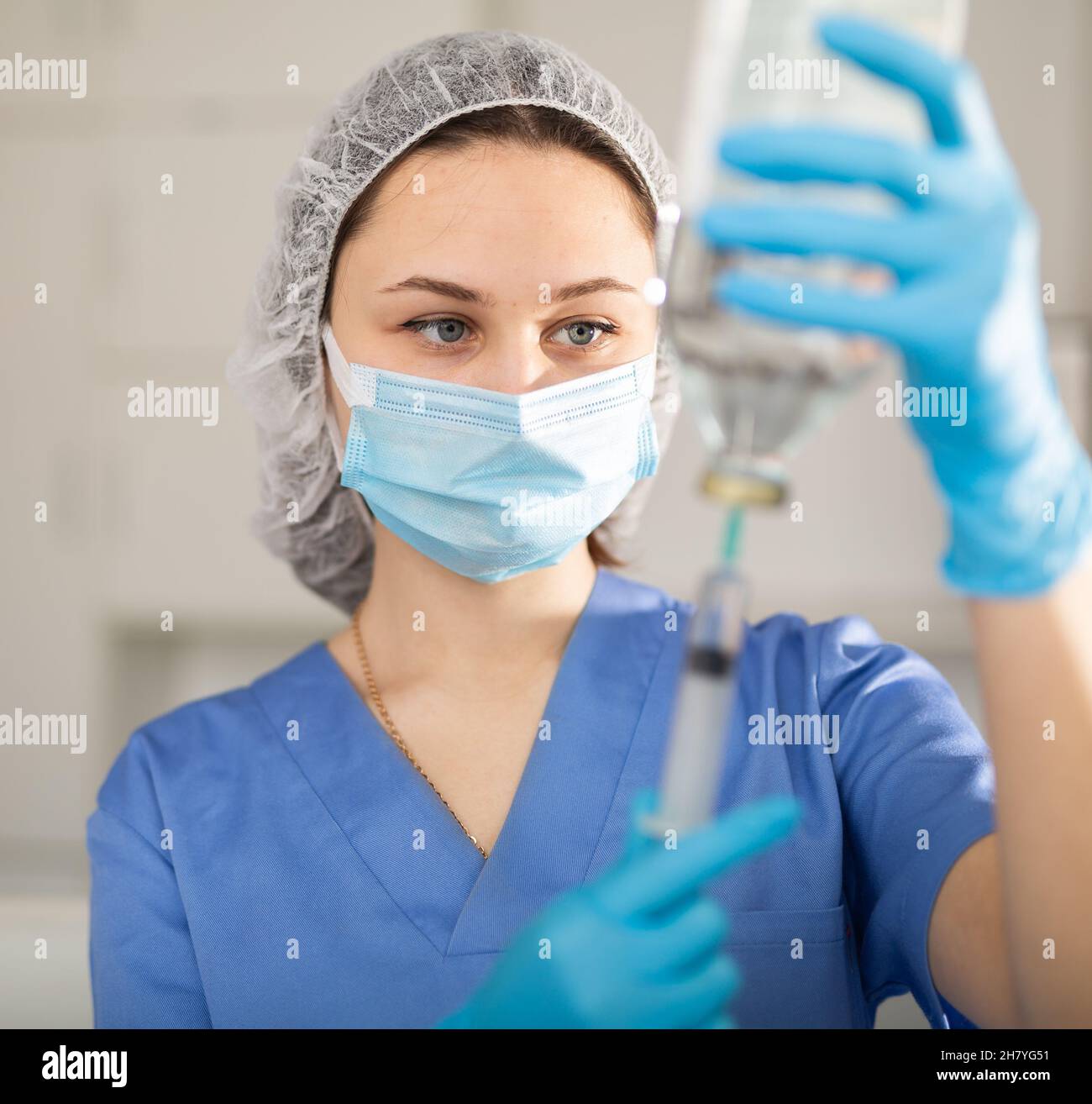 Young female nurse in the treatment room at the clinic prepares a ...