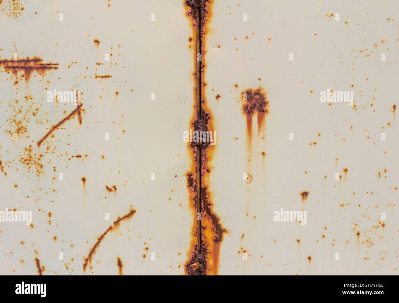 A rusty white metal wall. Metal background with streaks and rust spots ...